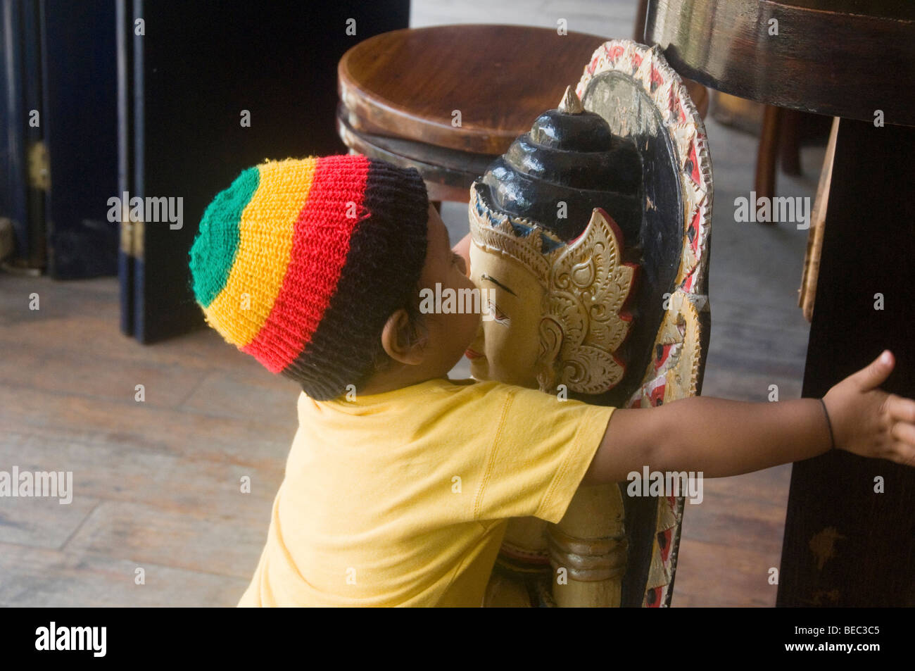 little boy kissing a statue in Bali Indonesia Stock Photo - Alamy