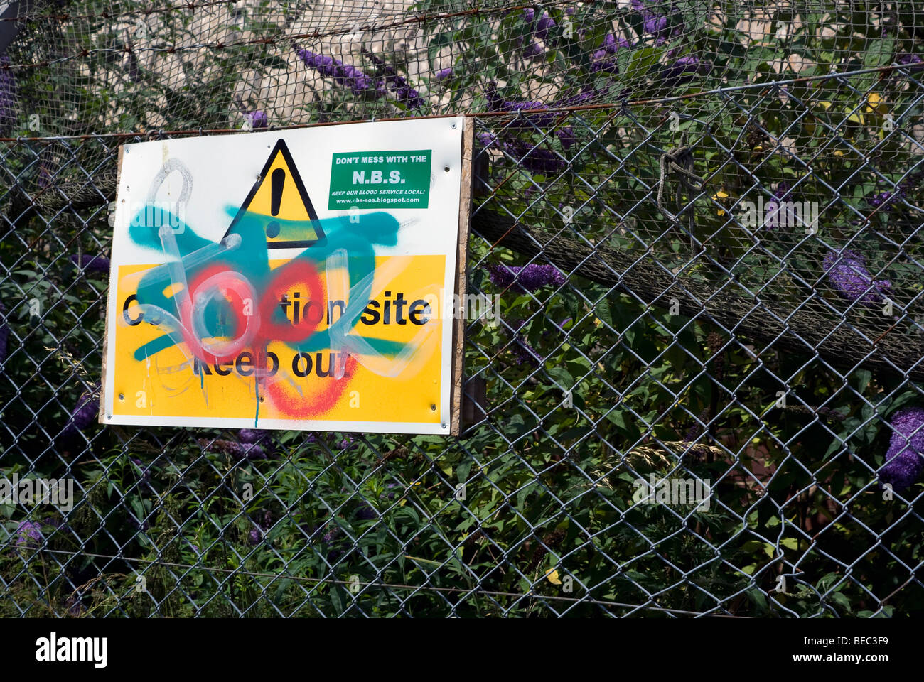 Keep Out sign covered in graffiti, on a fence Stock Photo - Alamy