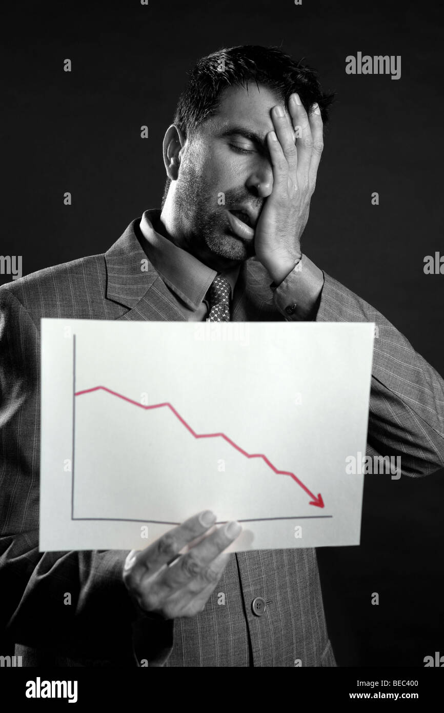 Businessman with bad sales reports chart. Crisis Stock Photo - Alamy