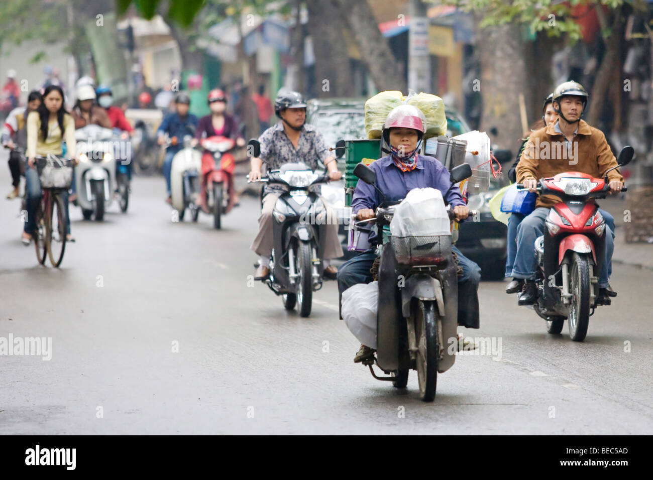 People riding scooters/mopeds in Vietnam in Hanoi Stock Photo - Alamy