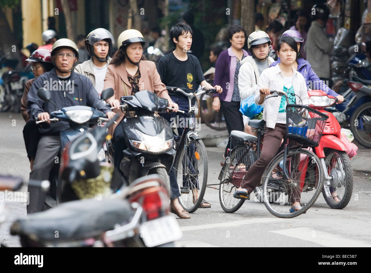 People riding scooters/mopeds in Vietnam in Hanoi Stock Photo - Alamy