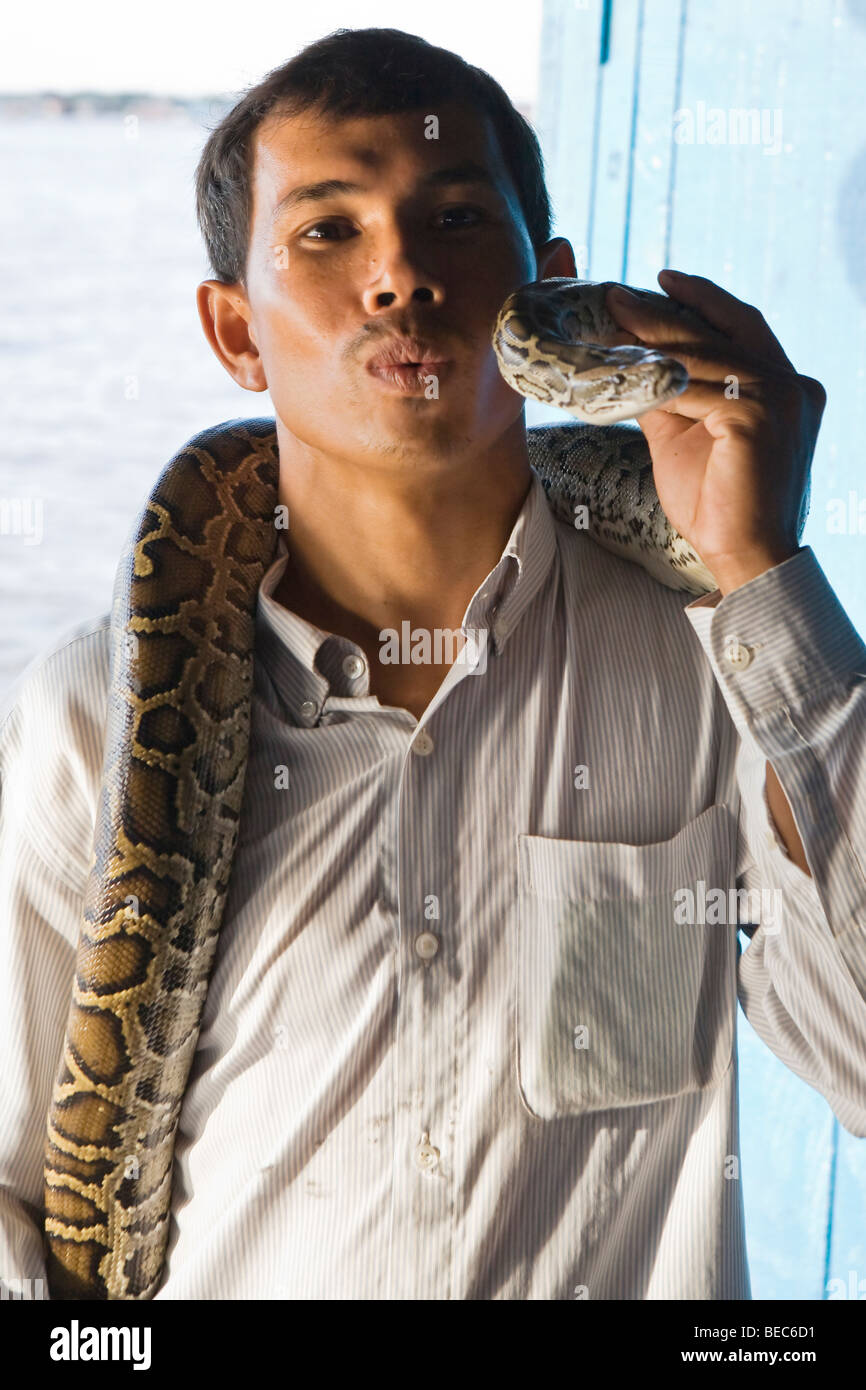 Man posing with a snake around his shoulders in South East Asia Stock ...