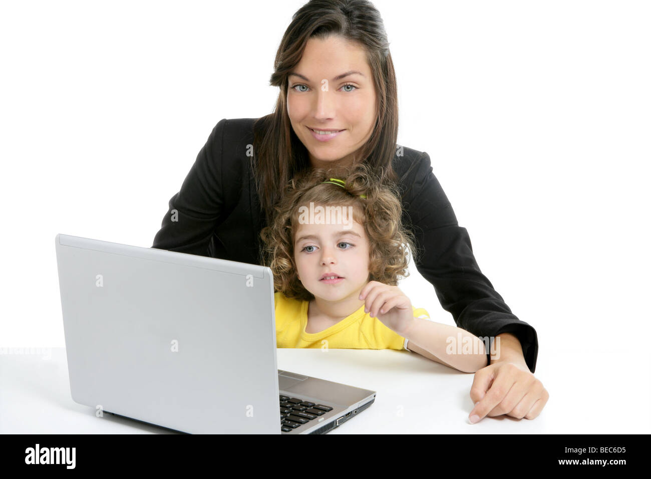 Beautiful mother and daughter with laptop computer on white background ...