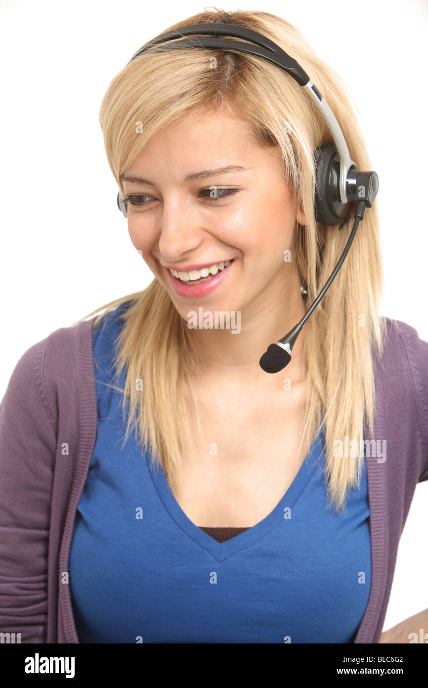 A smiling blonde girl answering with a headset Stock Photo - Alamy
