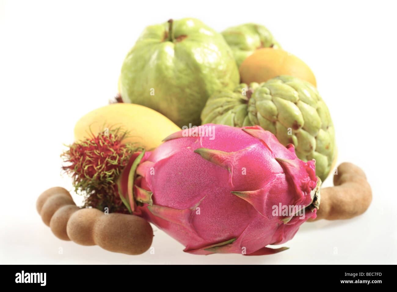 An assortment of tropical fruits, comprising dragonfruit (in front ...