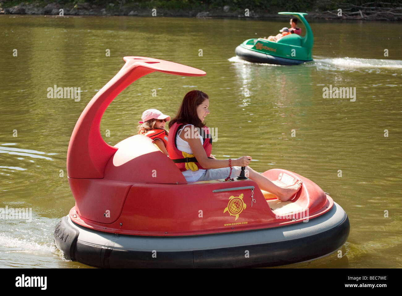 A family having fun in hover boats on the River Lot at Castelmoron ...