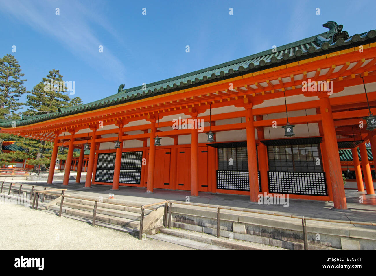 Vermilion Shinto building with trees and blue sky at Heian Jingu (Heian ...