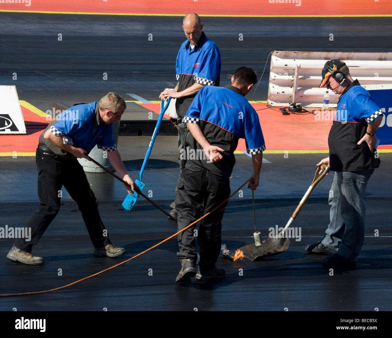 Staff at Santa Pod Raceway burning rubber of the track, at Santa Pod ...