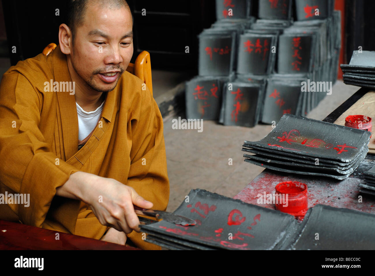 Buddhist monk inscribing roof tiles for donations, Da Fo Si monastery ...