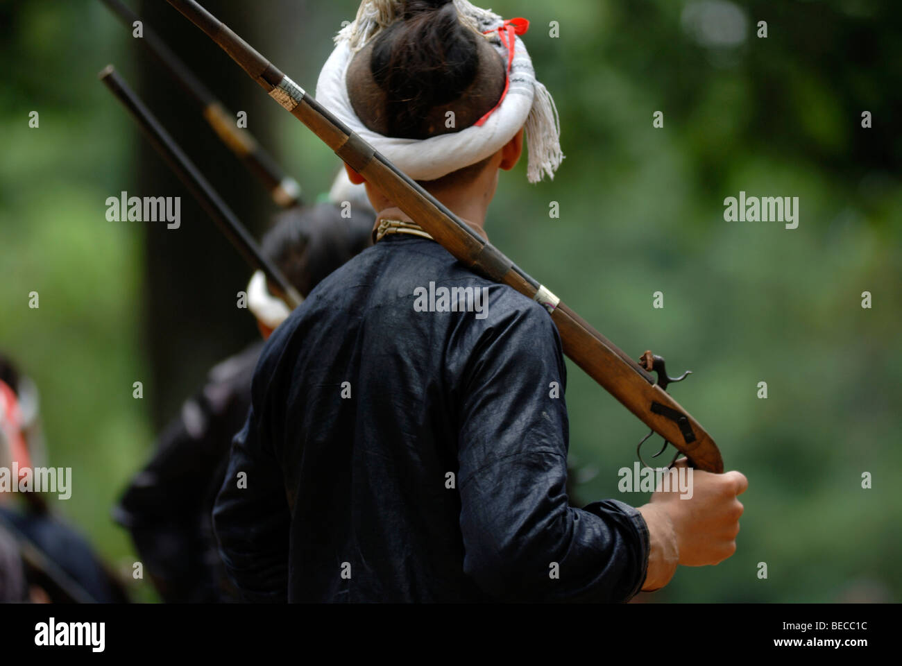 Man of the Basha minority with a gun at a shooting ceremony, Basha ...