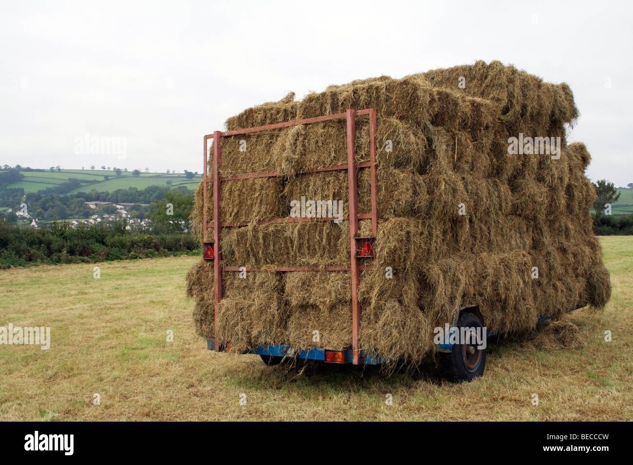 Large haystack on a trailer in a field Stock Photo - Alamy