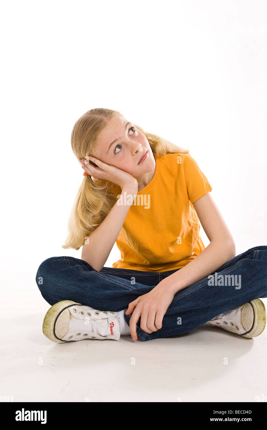 Sad girl sitting cross legged hi-res stock photography and images - Alamy