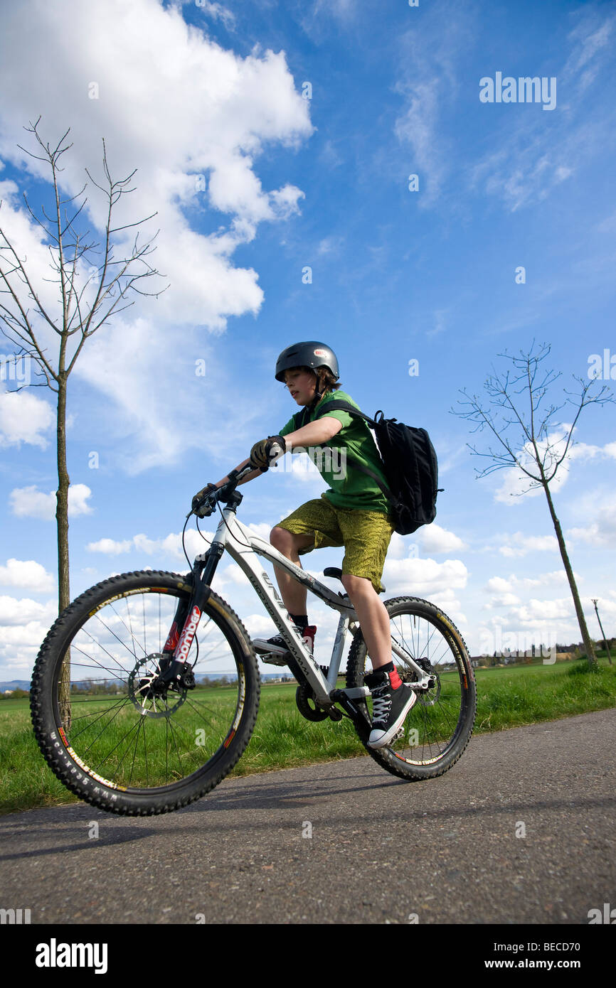 A boy on a mountain bike during a bike tour Stock Photo - Alamy