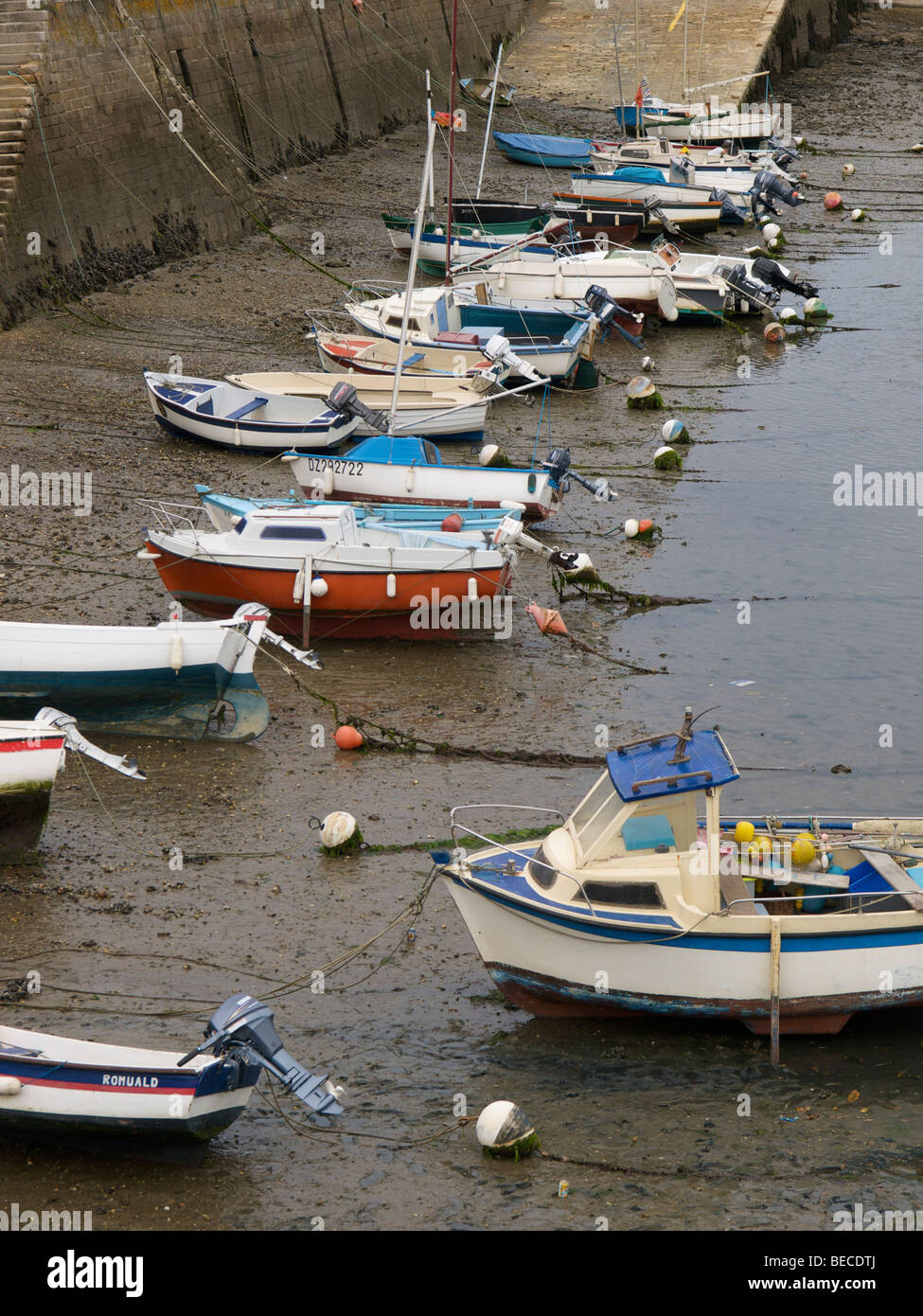 Small boats at low tide in the port of Douarnenez, Brittany, France ...