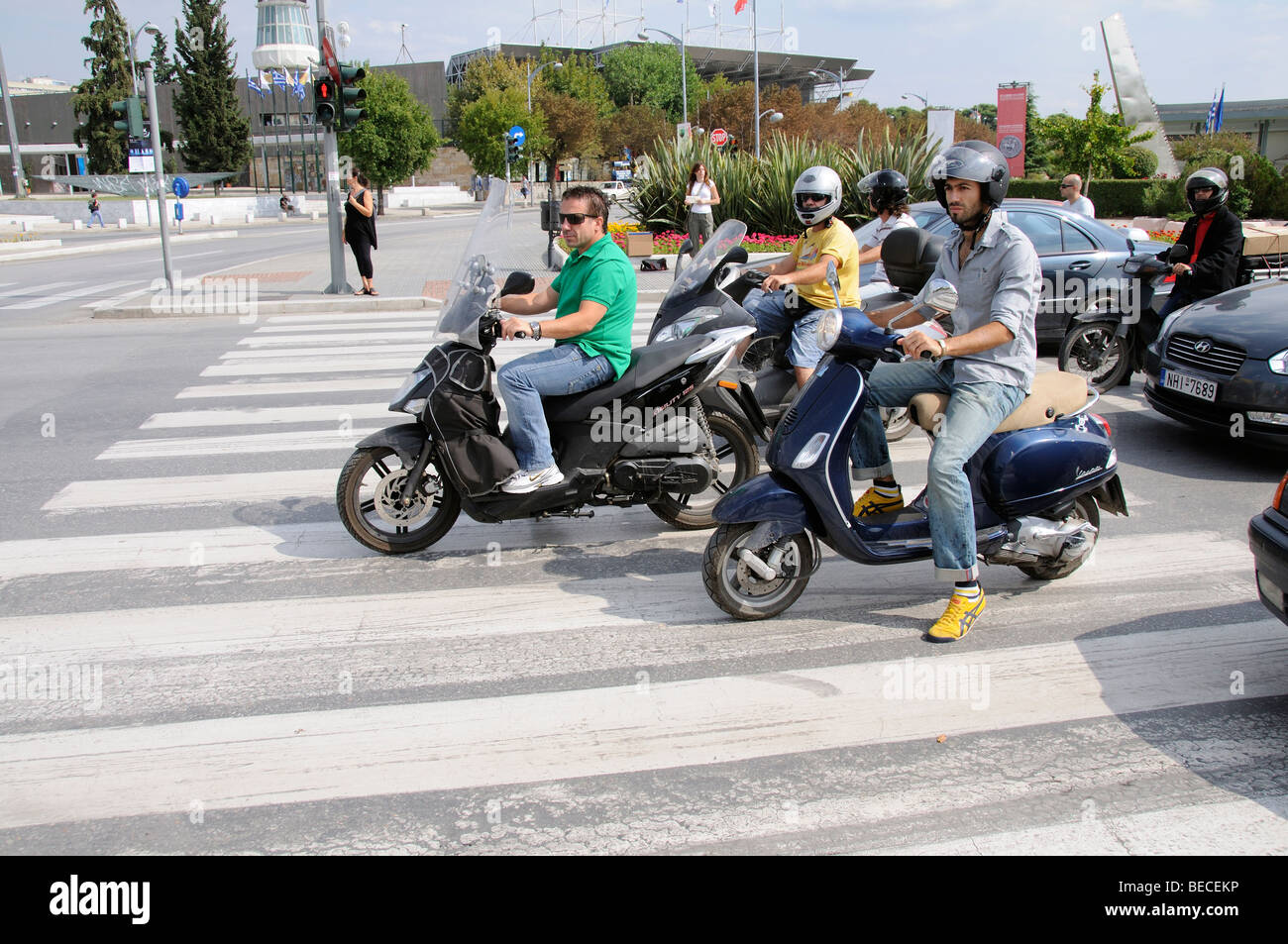 Motor scooter riders on a pedestrian crossing in central Thessaloniki ...