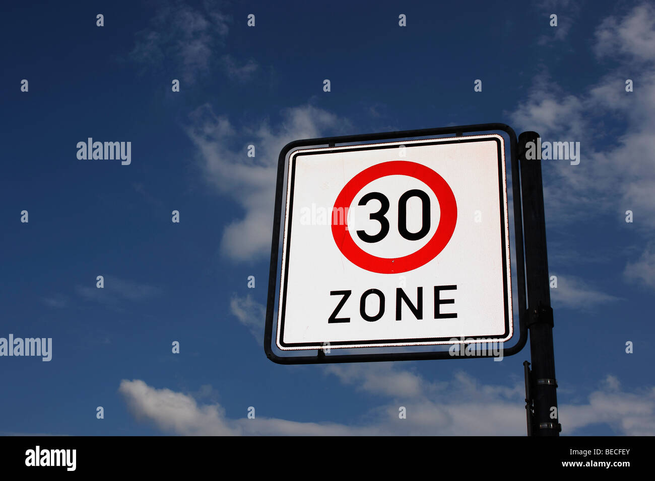 Traffic sign 30-zone it with blue sky and clouds Stock Photo - Alamy