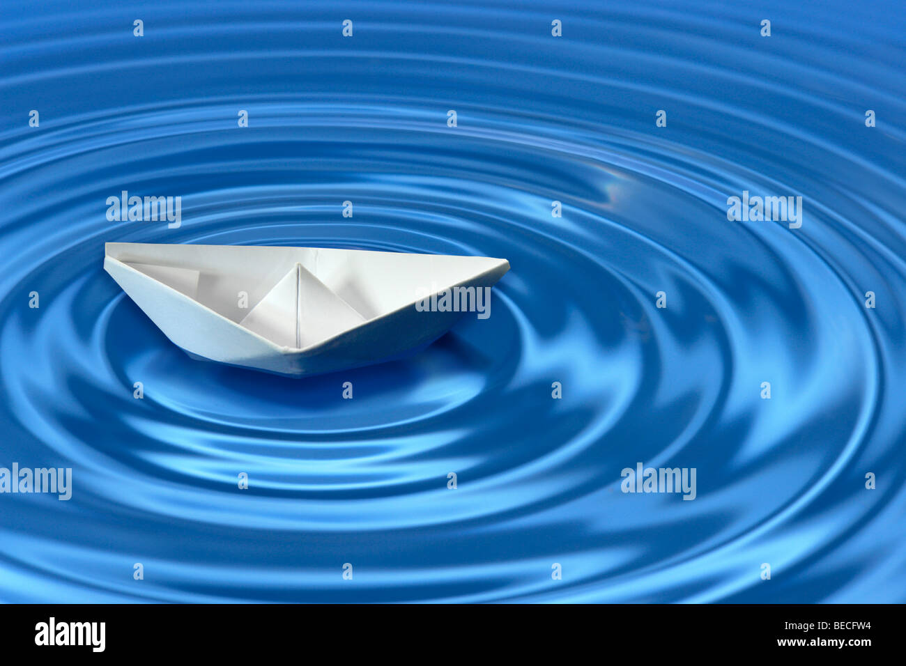 Paper ship floating on water Stock Photo - Alamy