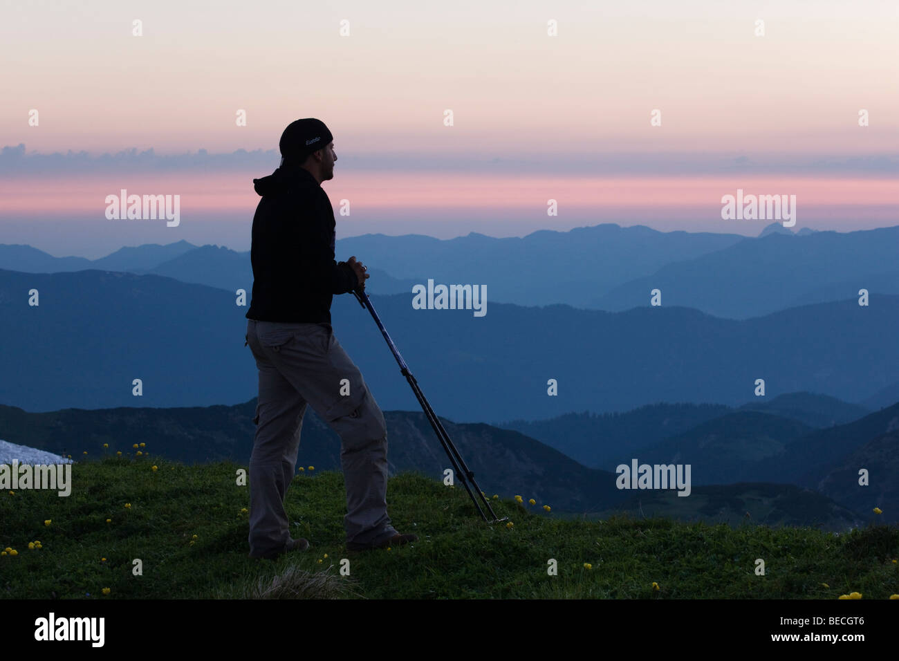 Hiker looking at mountains after sunset, Rofan Range, North Tyrol ...