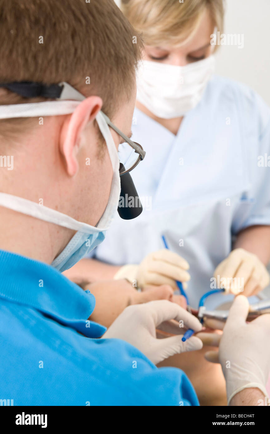 Dentist and dental nurse treating a patient Stock Photo - Alamy