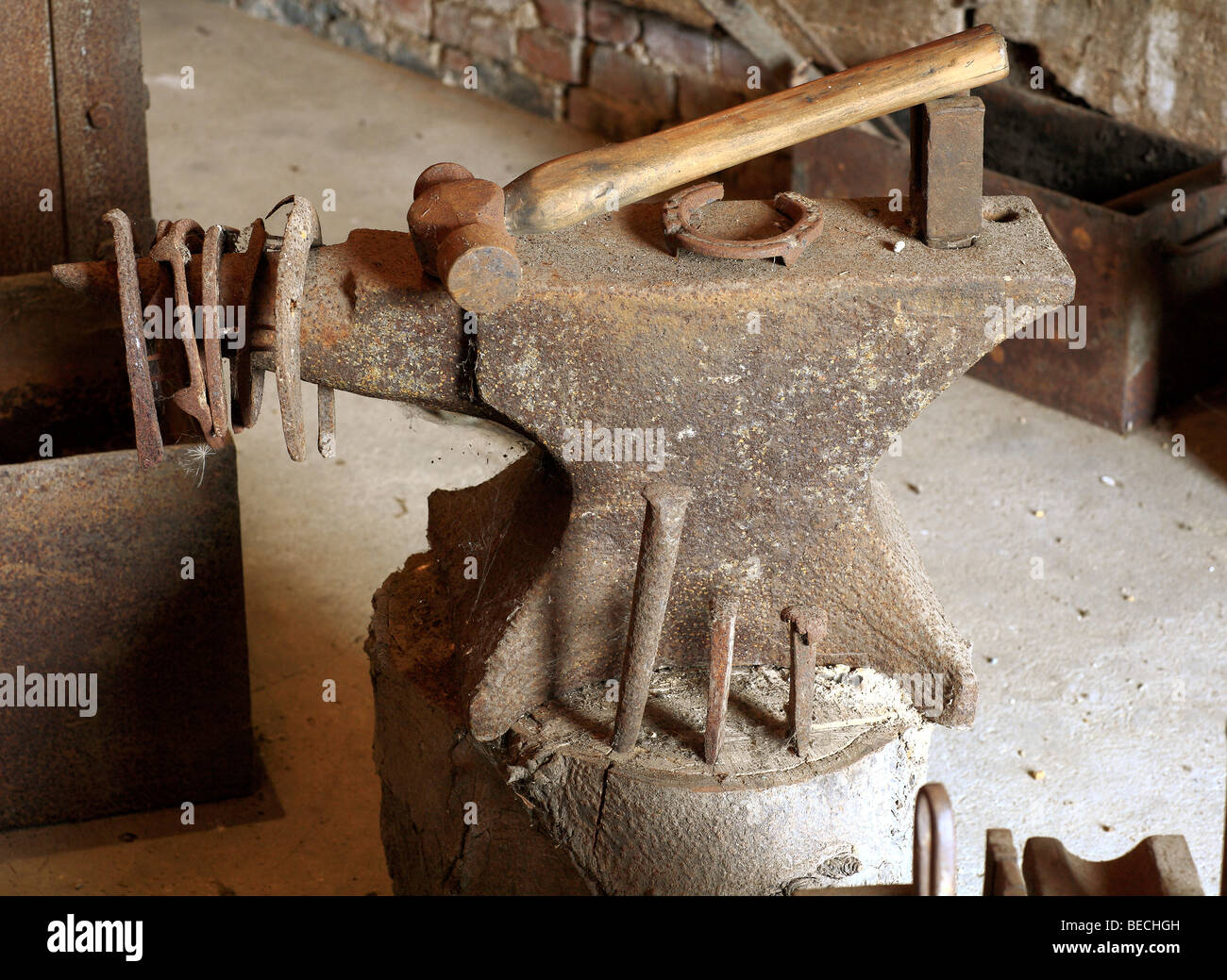 Old anvil and tools in a forge at Cressing Temple Barns Essex England ...