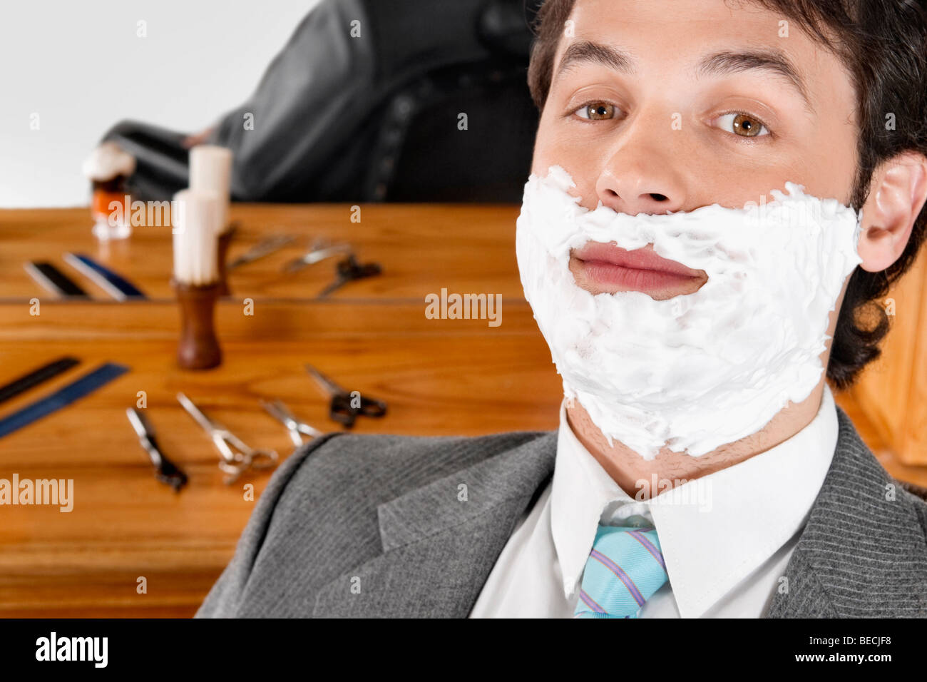 Man getting shaved in a salon Stock Photo - Alamy