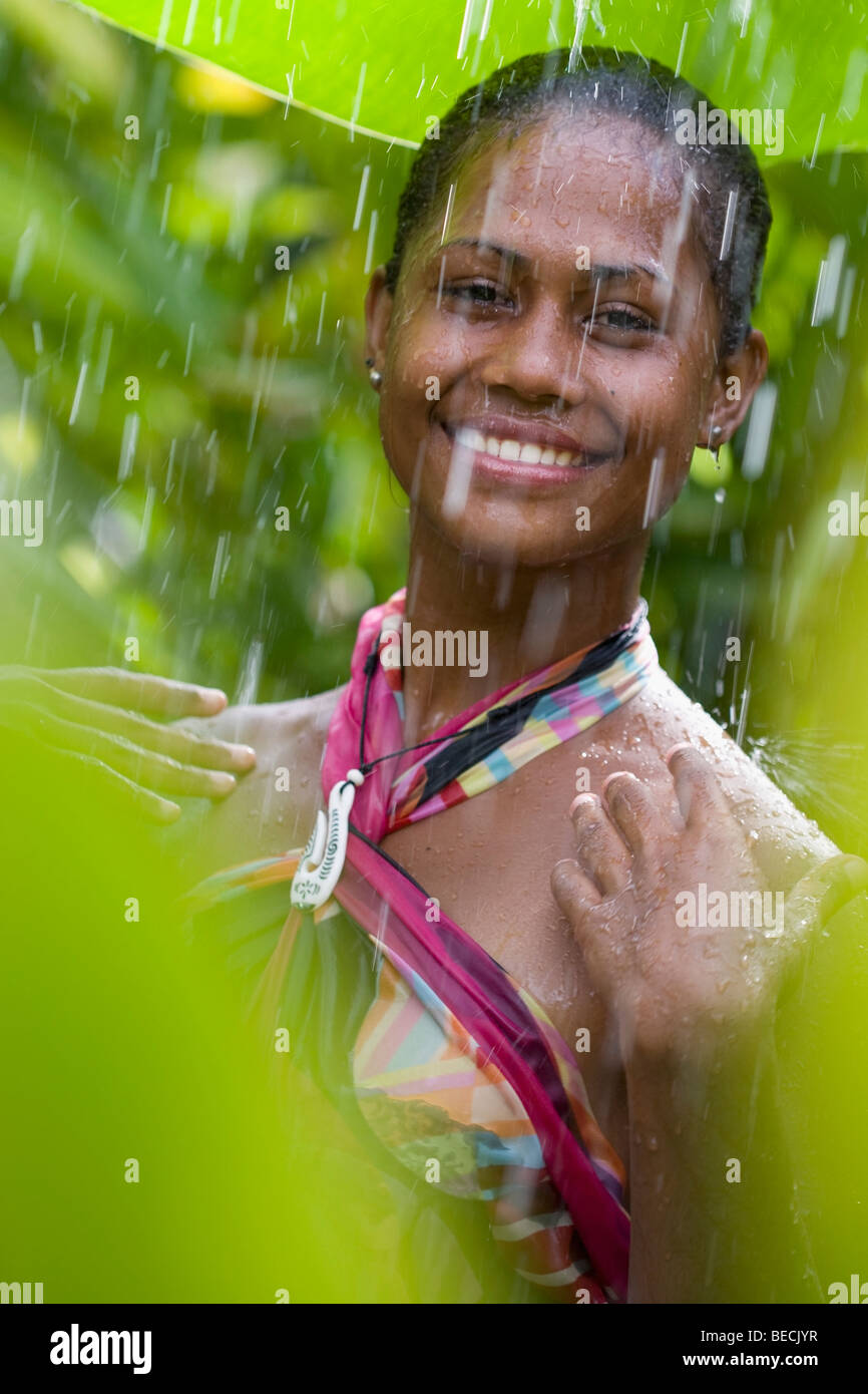 Portrait of a woman enjoying rain shower Stock Photo - Alamy