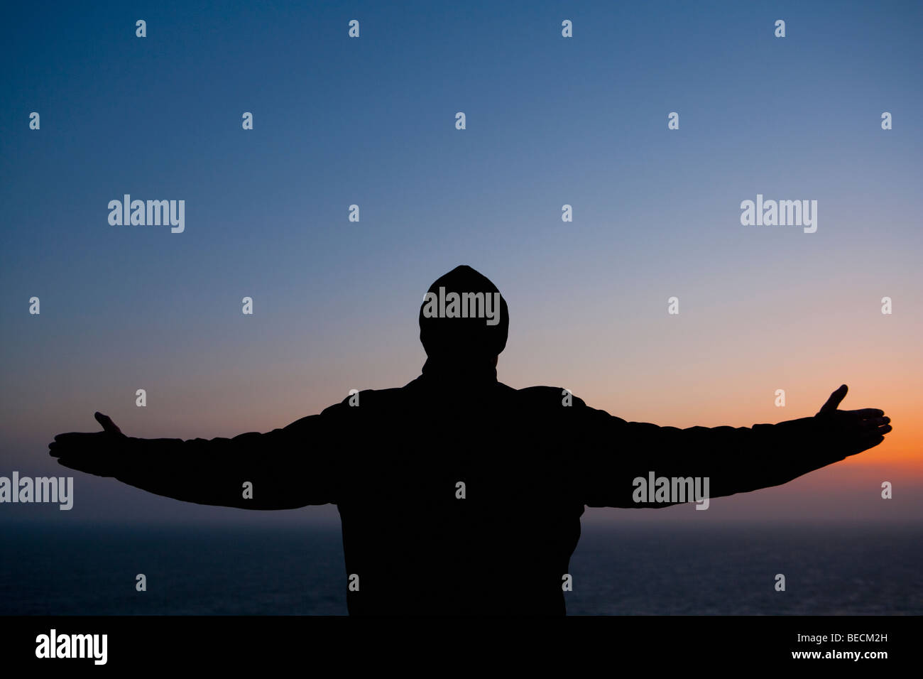 Silhouette of a man standing with his arms outstretched, San Francisco ...