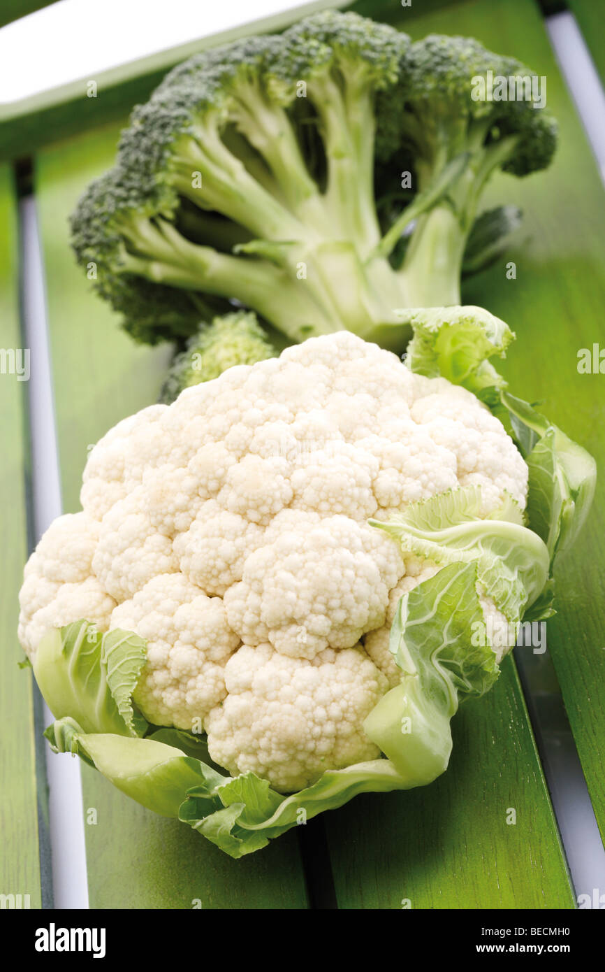 Small cauliflower and broccoli on a wooden board Stock Photo - Alamy