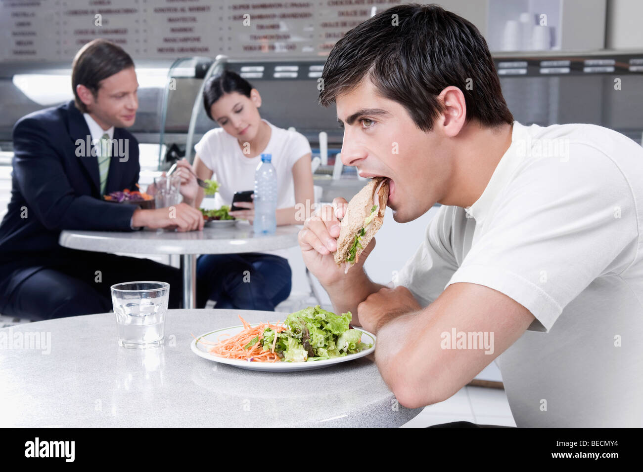 Man eating a sandwich in a restaurant Stock Photo - Alamy