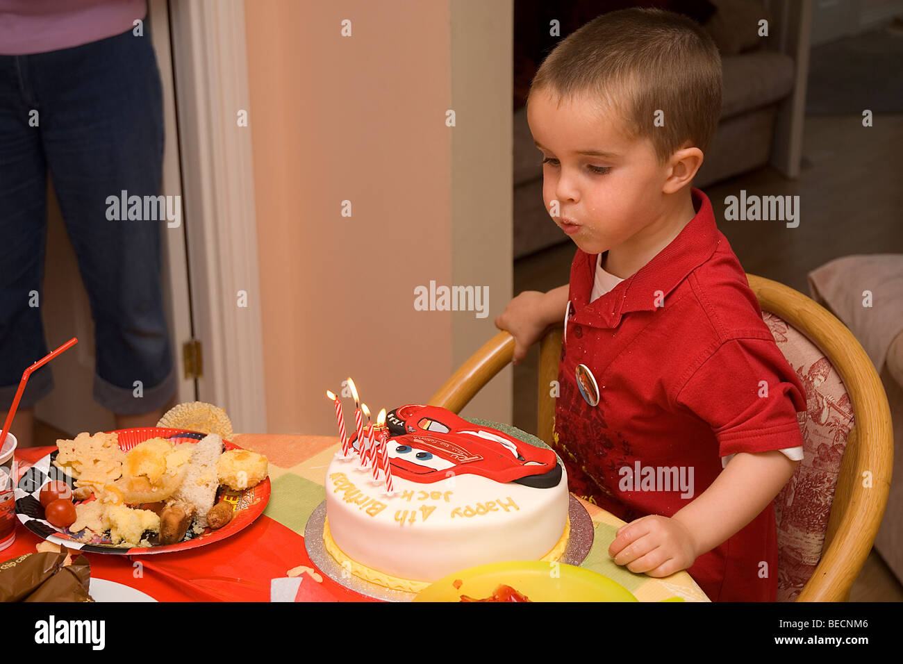 Young Boy Blowing Out Candles on a Birthday Cake Stock Photo - Alamy