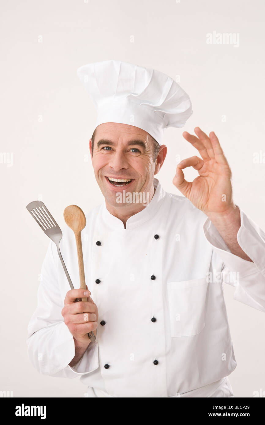 Cook laughing holding cooking utensils hi-res stock photography and ...