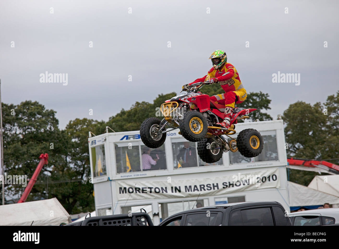 Kangaroo Kid alias Matt Coulter quad stunt bike in mid air over parked ...