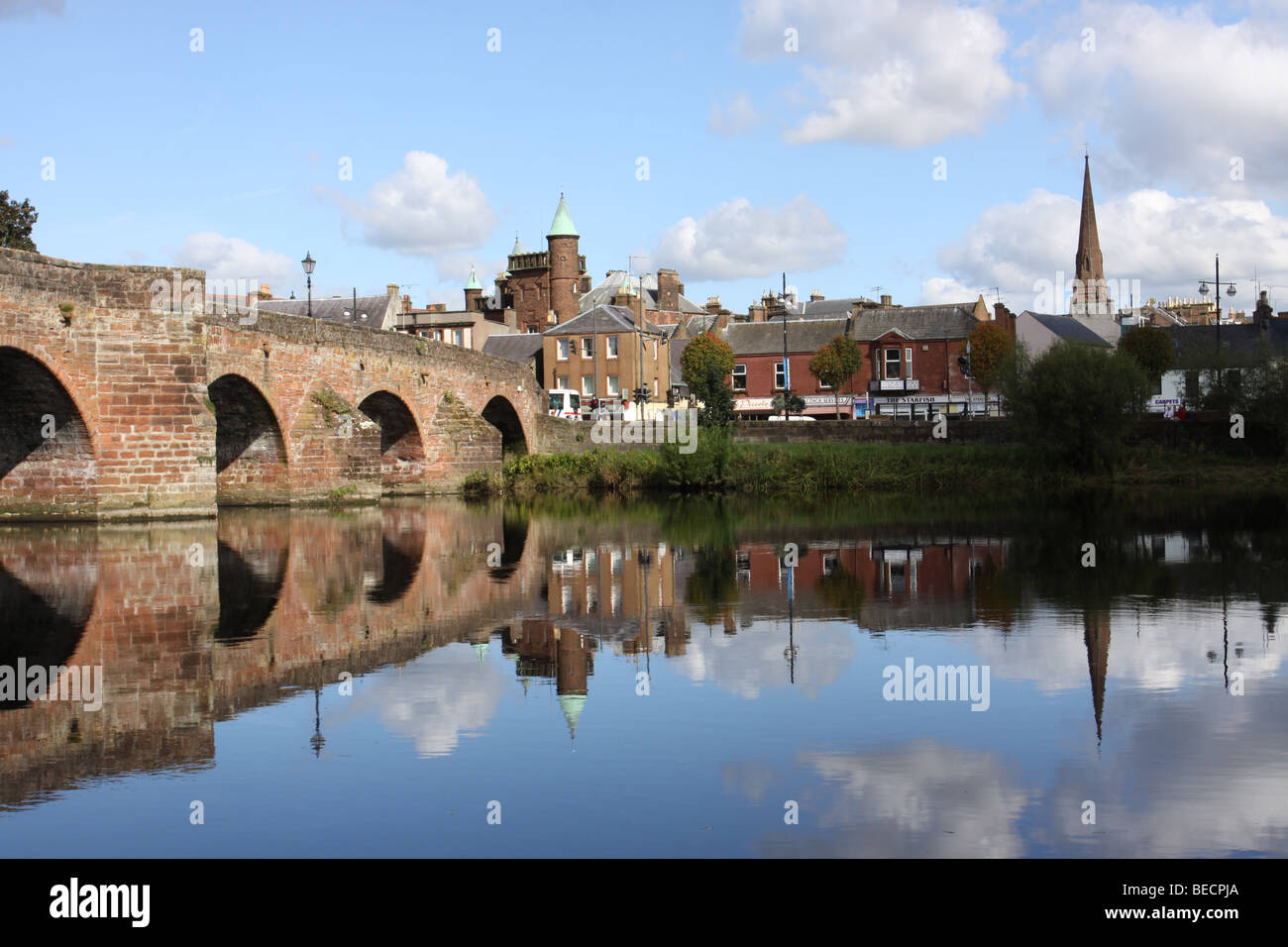 Devorgilla's Bridge reflected in River Nith and Dumfries skyline ...