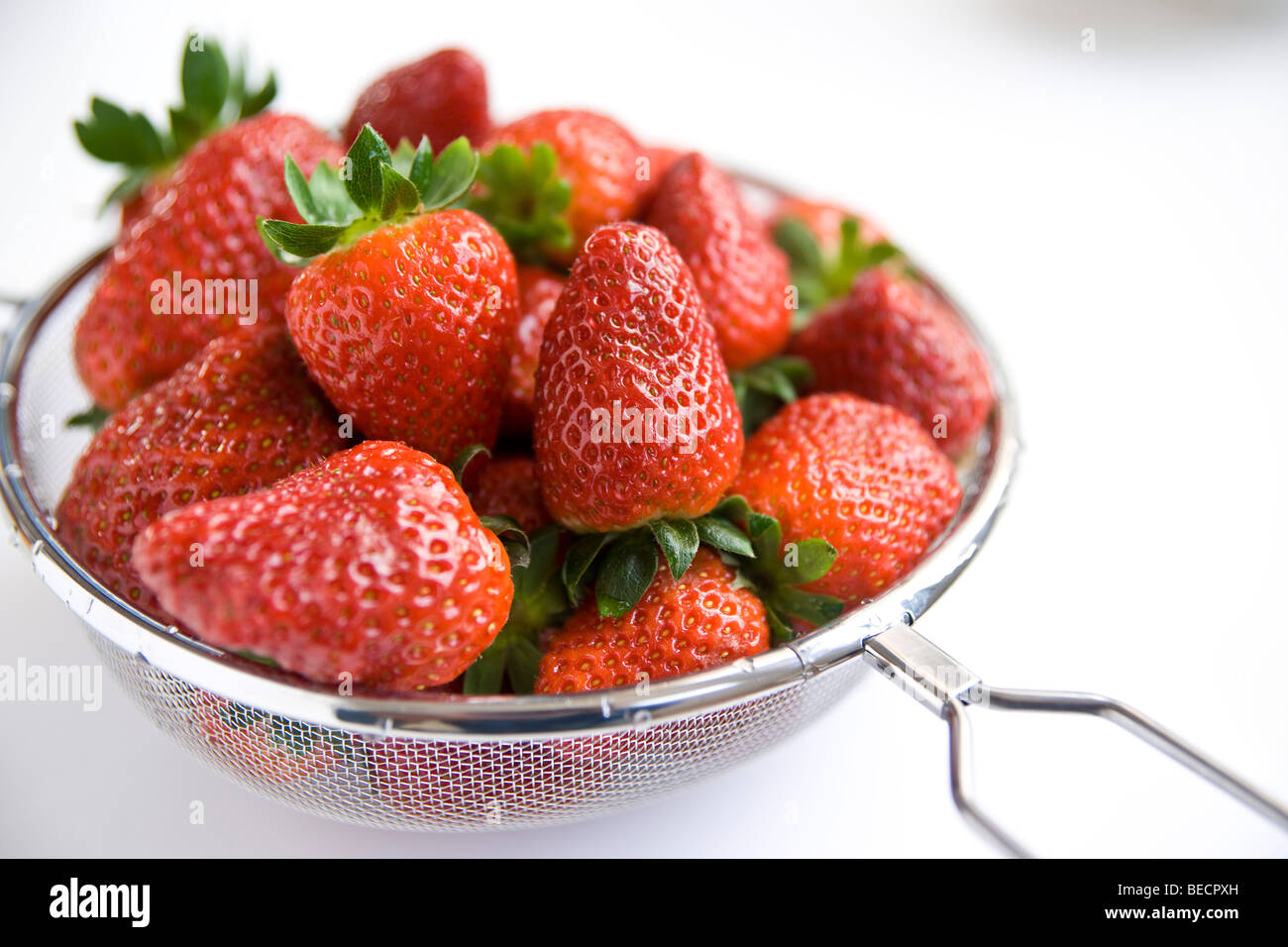 Strawberry in a colander hi-res stock photography and images - Alamy
