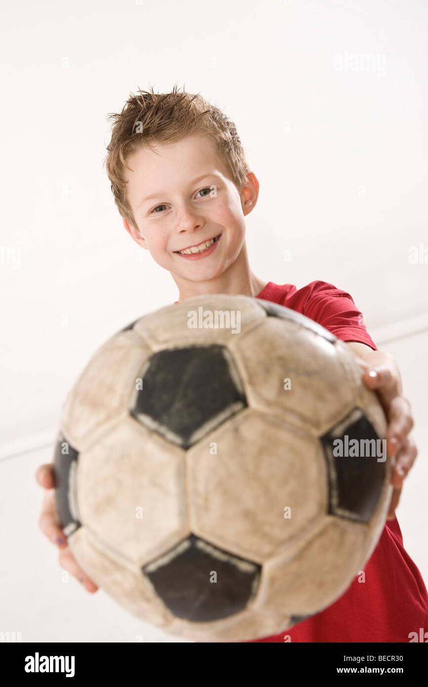 Portrait of a smiling boy with a football Stock Photo - Alamy