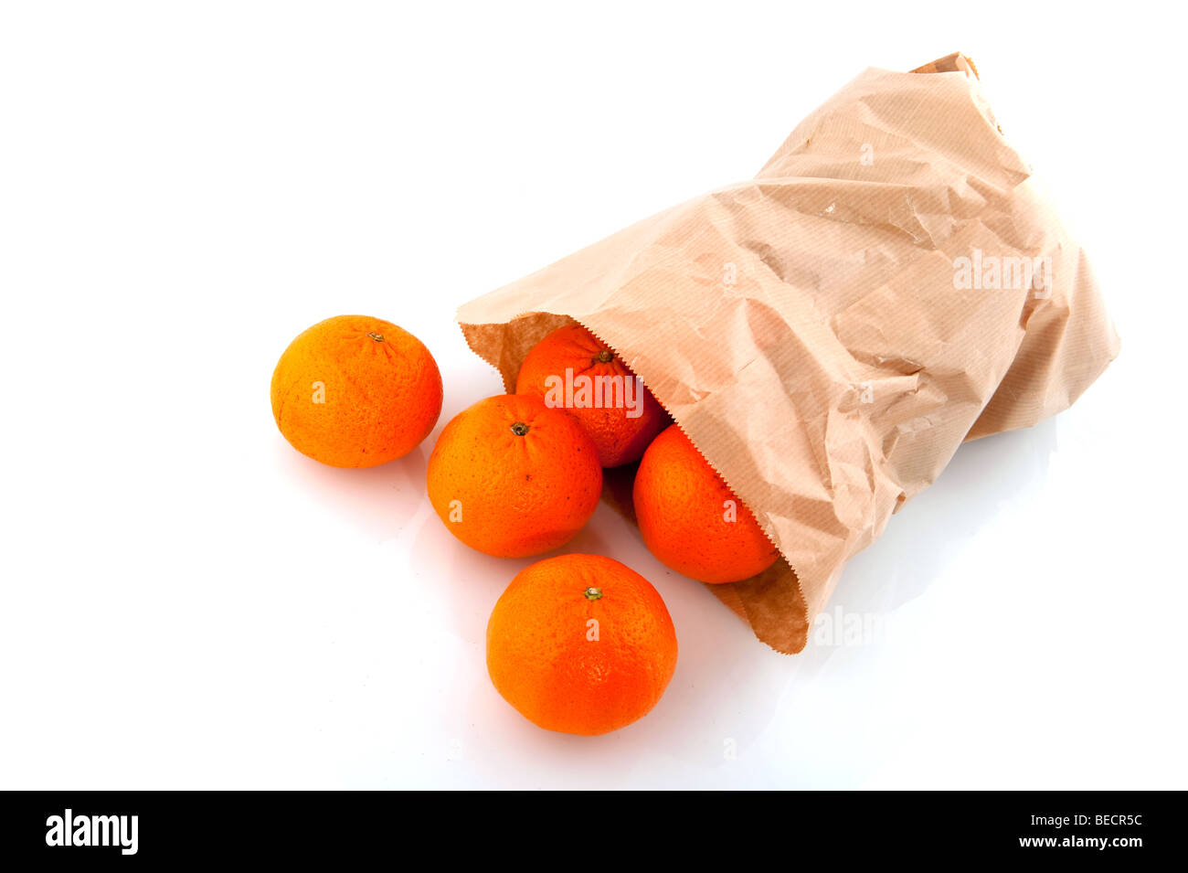 paper bag with tangerines isolated over white Stock Photo - Alamy