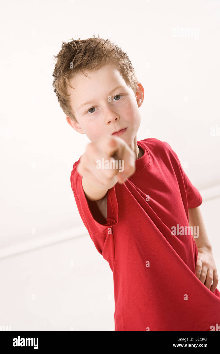 Portrait of a boy pointing forwards with his index finger Stock Photo ...
