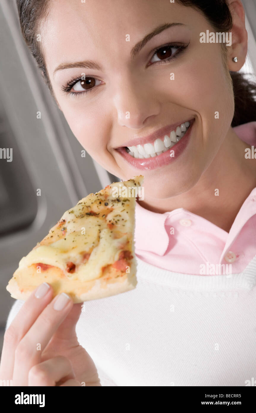 Portrait of female chef holding a pizza slice Stock Photo - Alamy