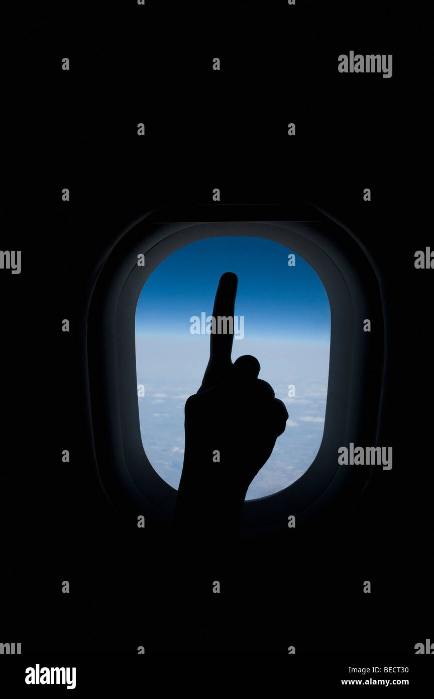 Close-up of a person's hand in front of an airplane window Stock Photo ...