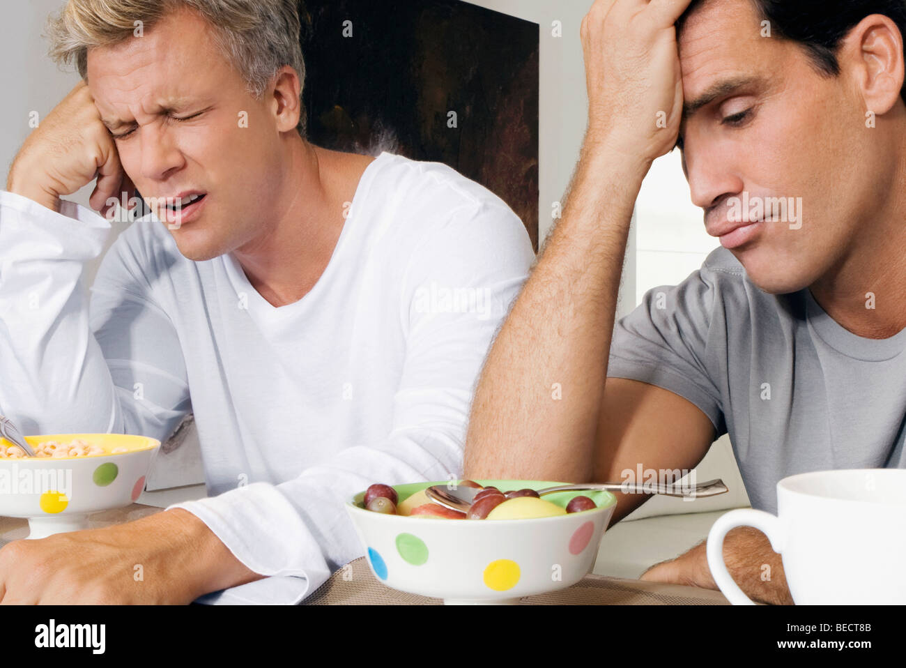 Men frowning at bowls of cereal and fruits Stock Photo - Alamy