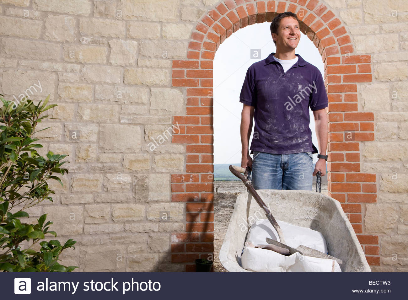 Man With Wheelbarrow Stock Photos & Man With Wheelbarrow Stock Images ...