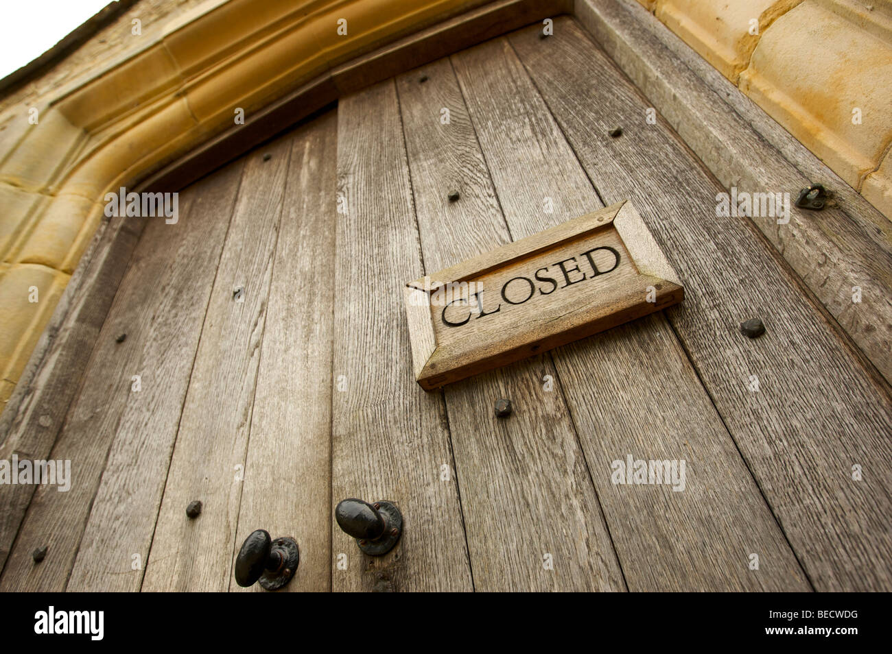 Closed sign on a large wooden medieval door Stock Photo - Alamy