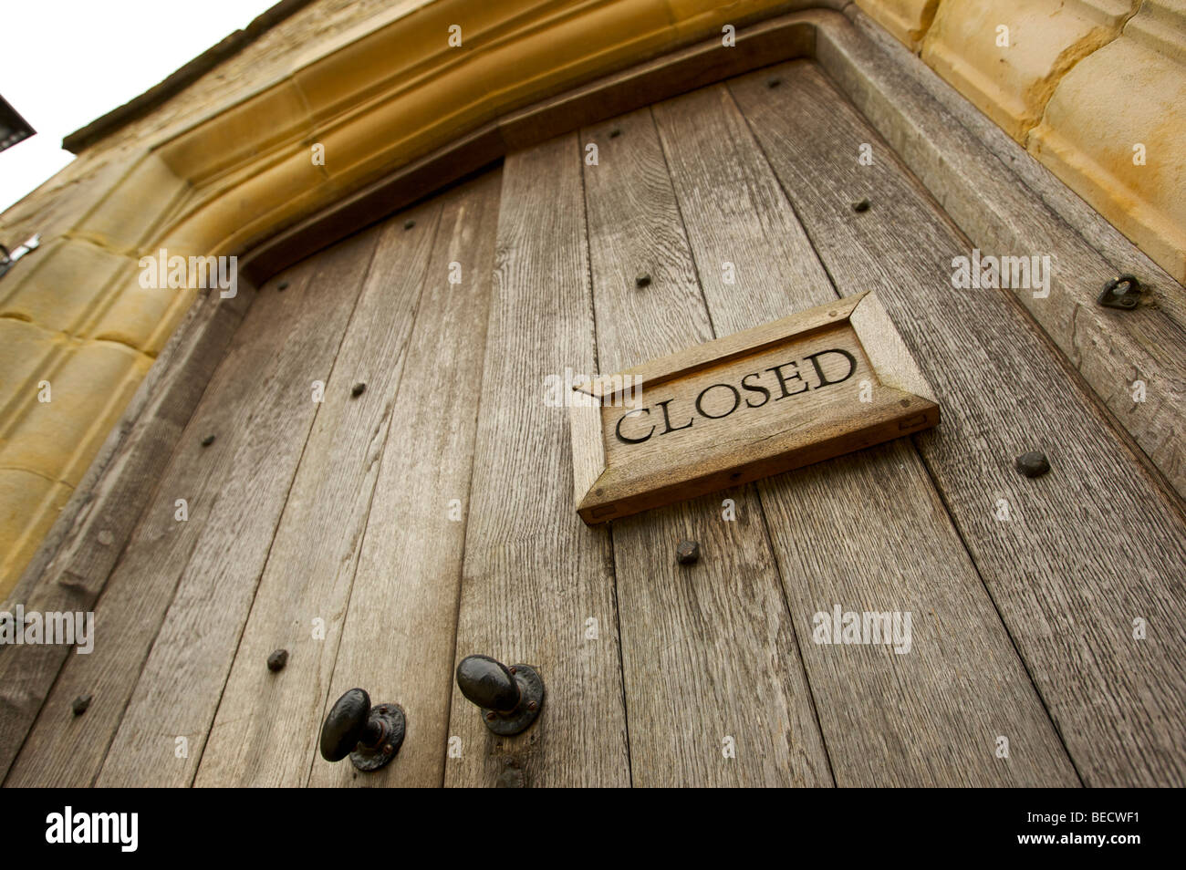 Closed sign on a large wooden medieval door Stock Photo - Alamy