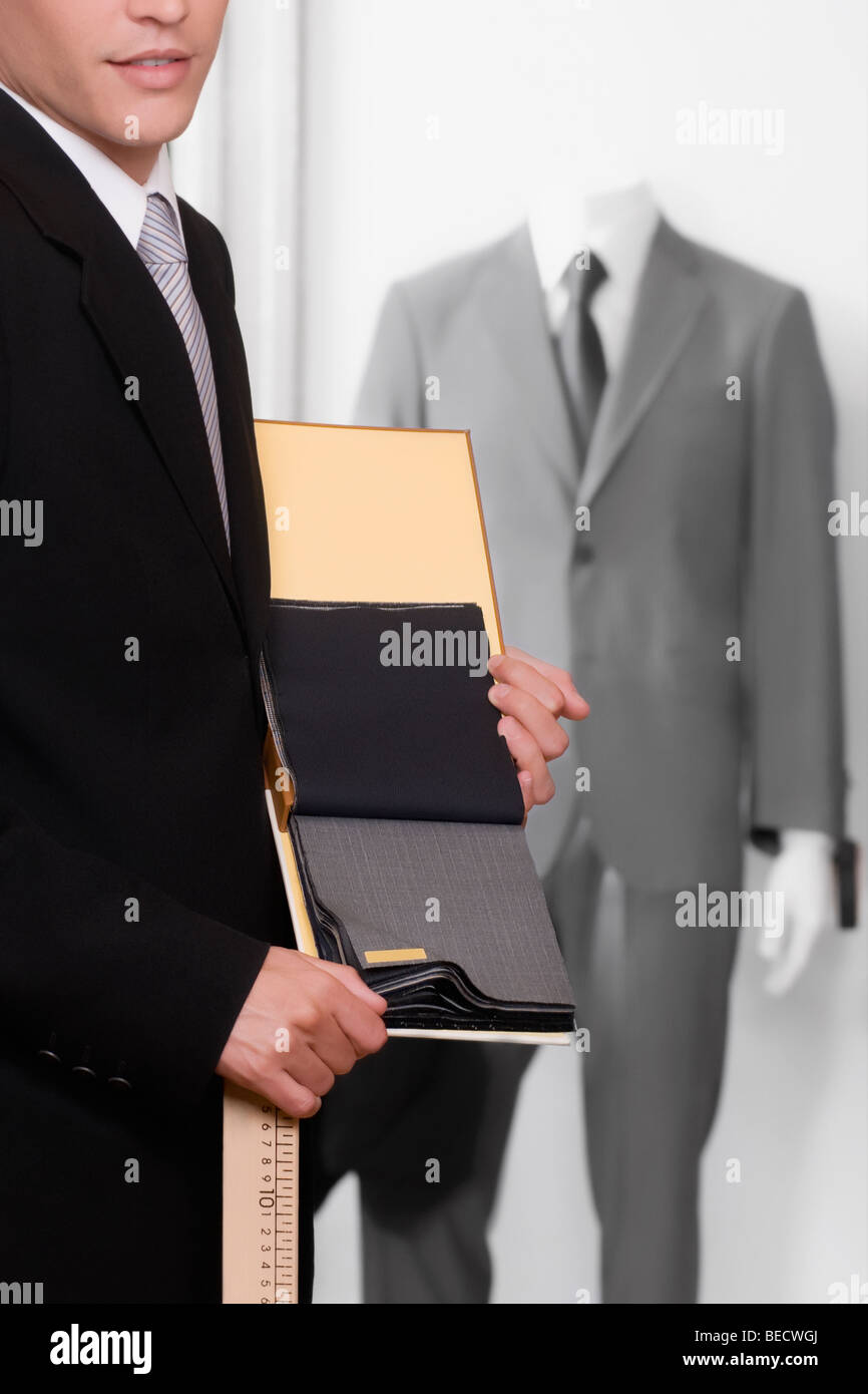 Customer holding fabric swatches in a clothing store Stock Photo - Alamy