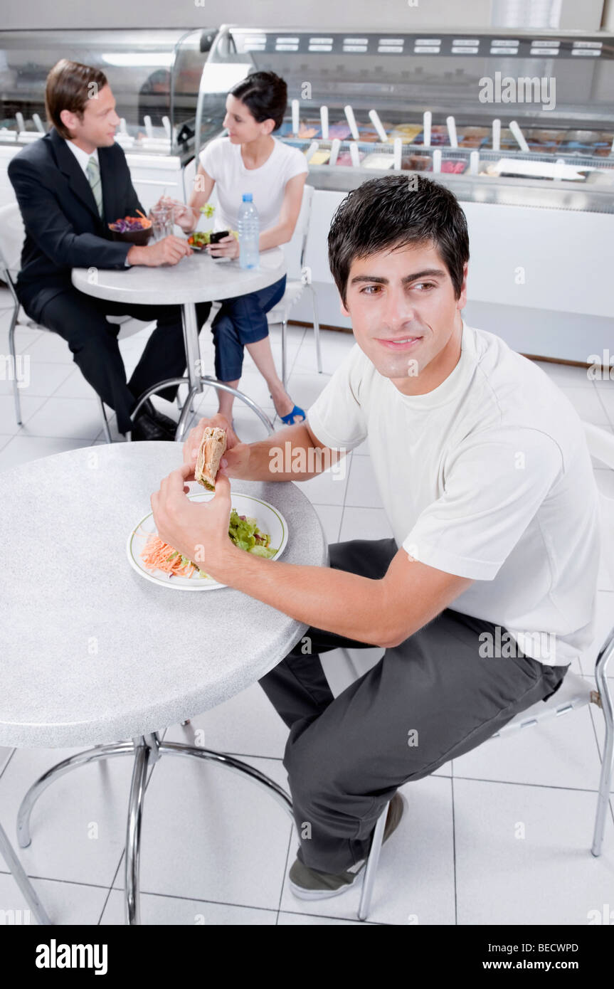 Man eating a sandwich in a restaurant Stock Photo - Alamy