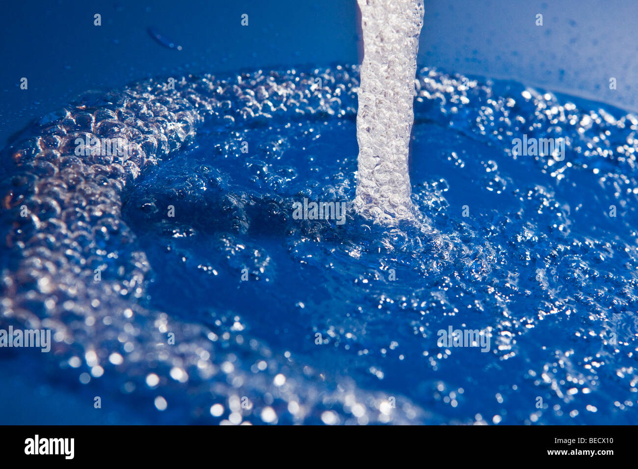 Water flowing into a basin, air bubbles Stock Photo - Alamy