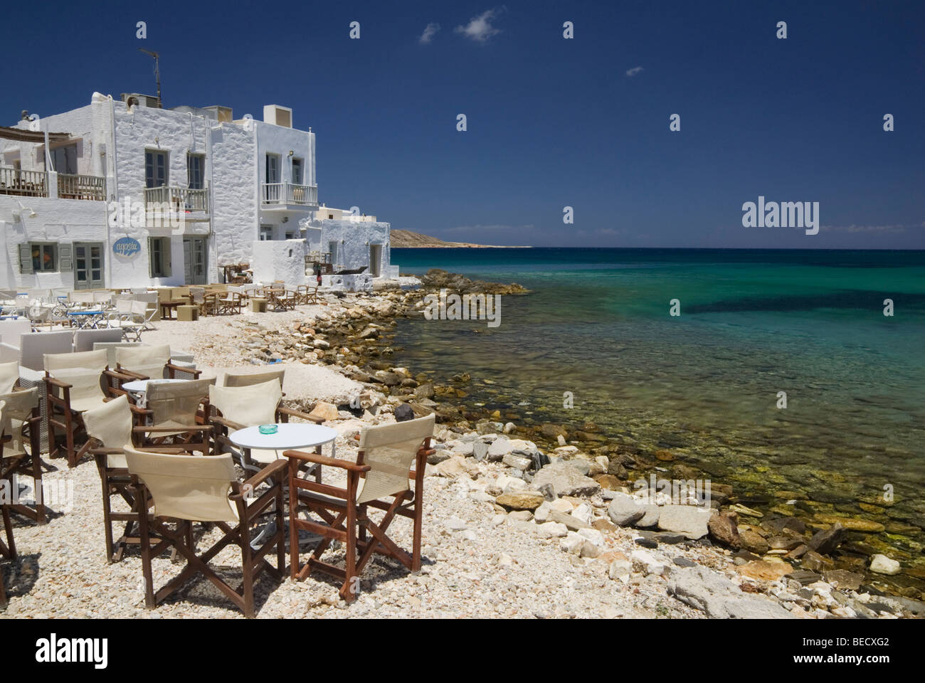 Tables and chairs close to the sea on Naoussa's town beach, Paros ...