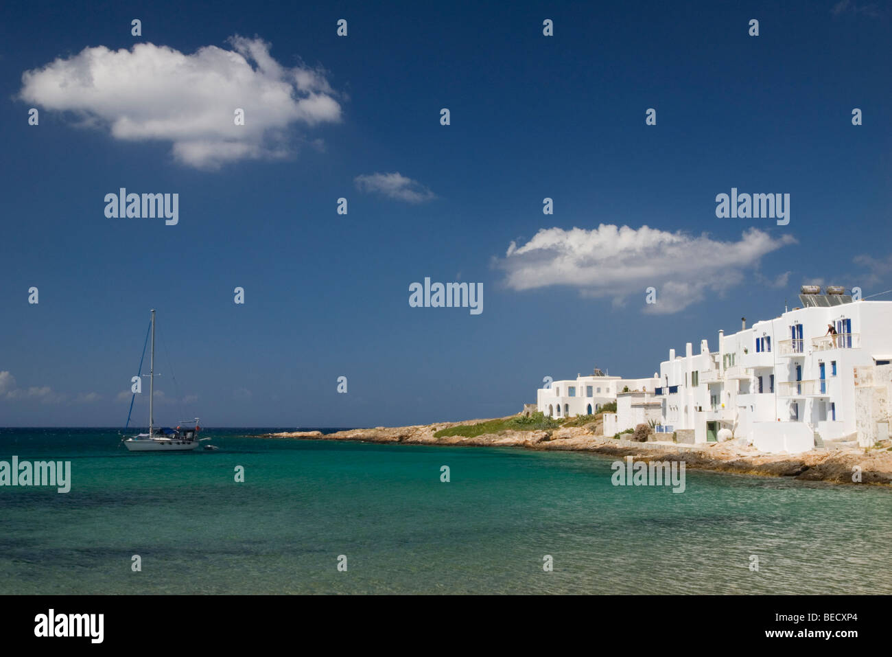 A lone yacht anchored off Naoussa's Town beach on the island of Paros ...