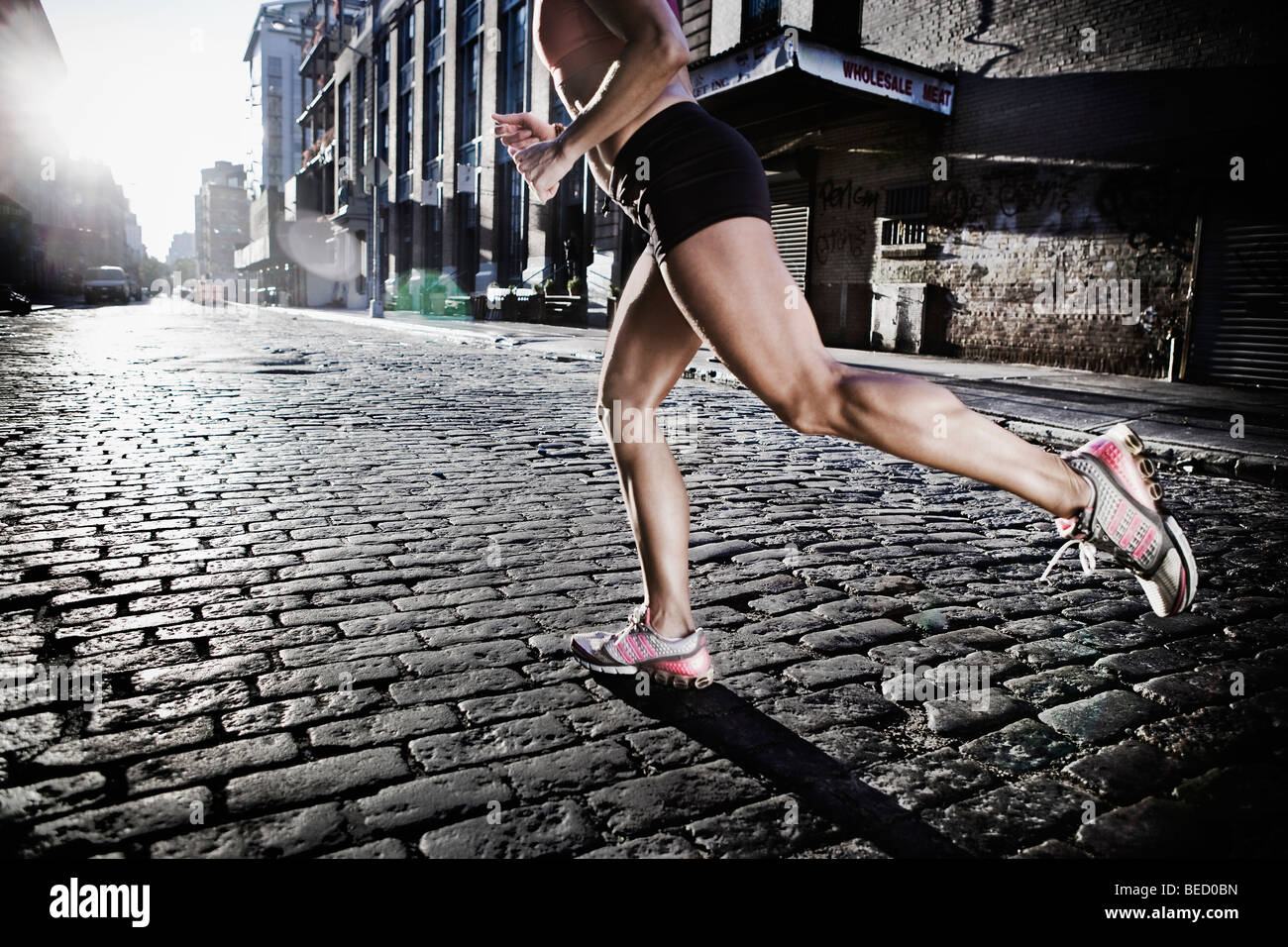 Low section view of a woman jogging in the street Stock Photo - Alamy