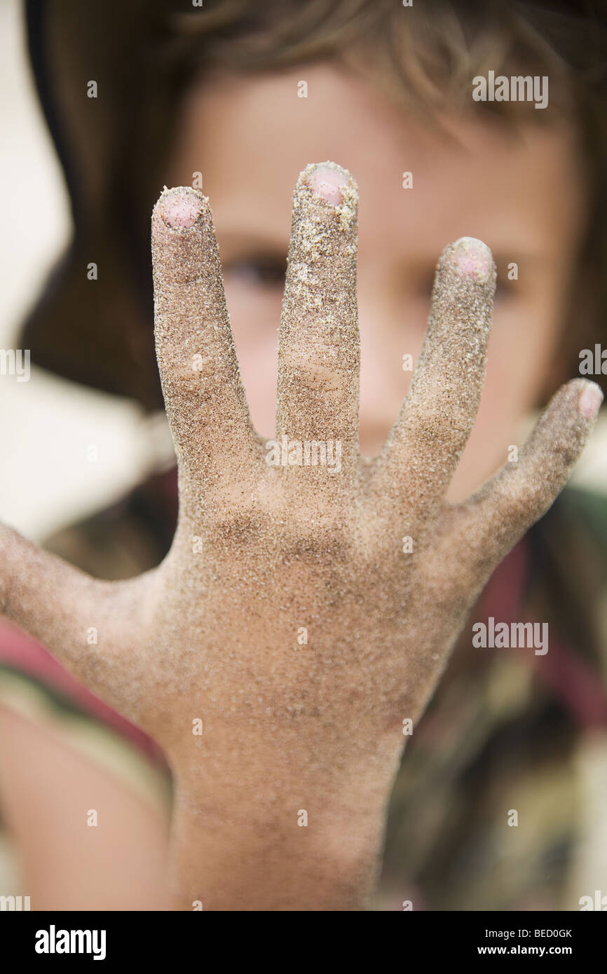 Boy showing his muddy hand Stock Photo - Alamy